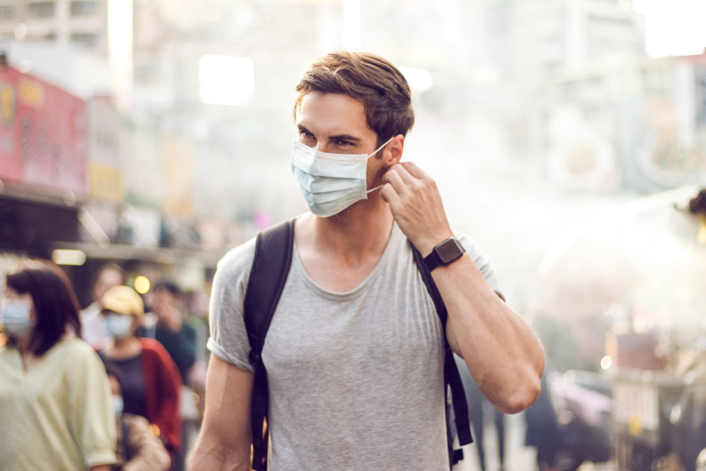 man walking down street with mask on face - Tampa T-Shirts